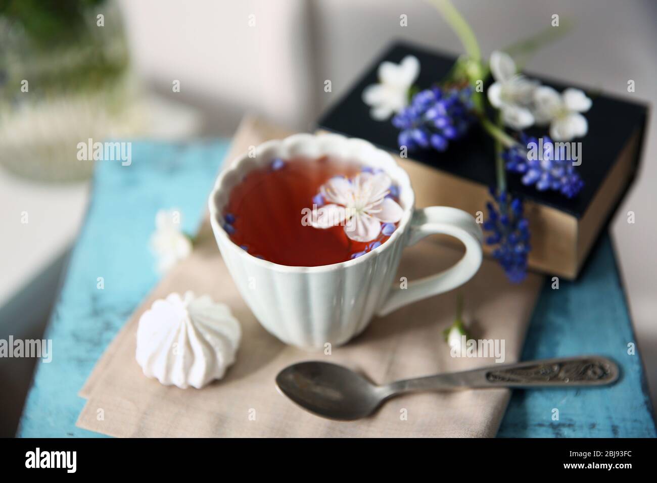 Cup of tea with flowers on wooden stool Stock Photo - Alamy