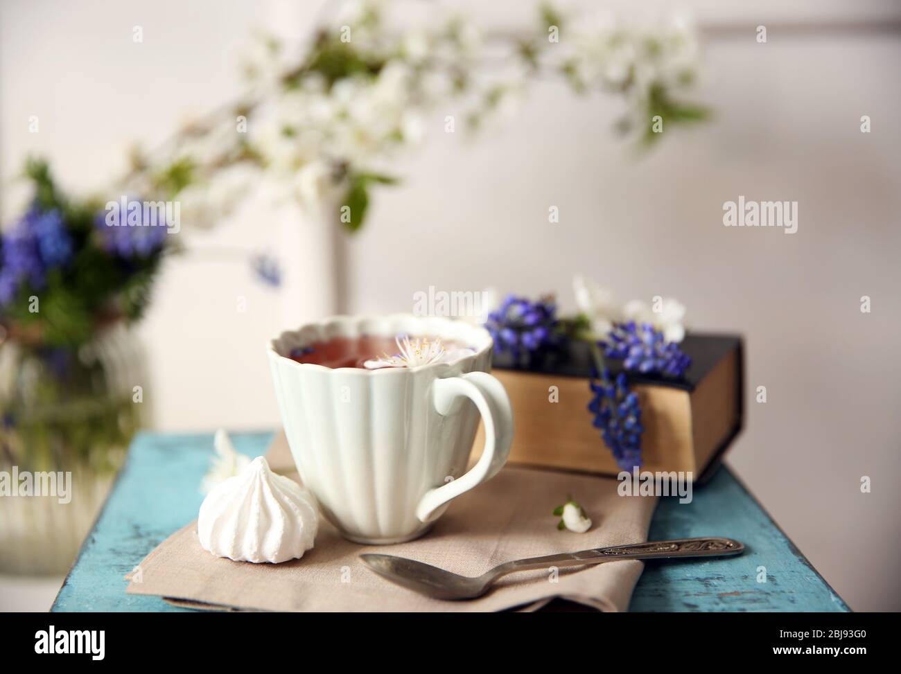 Cup of tea with flowers on wooden stool Stock Photo - Alamy
