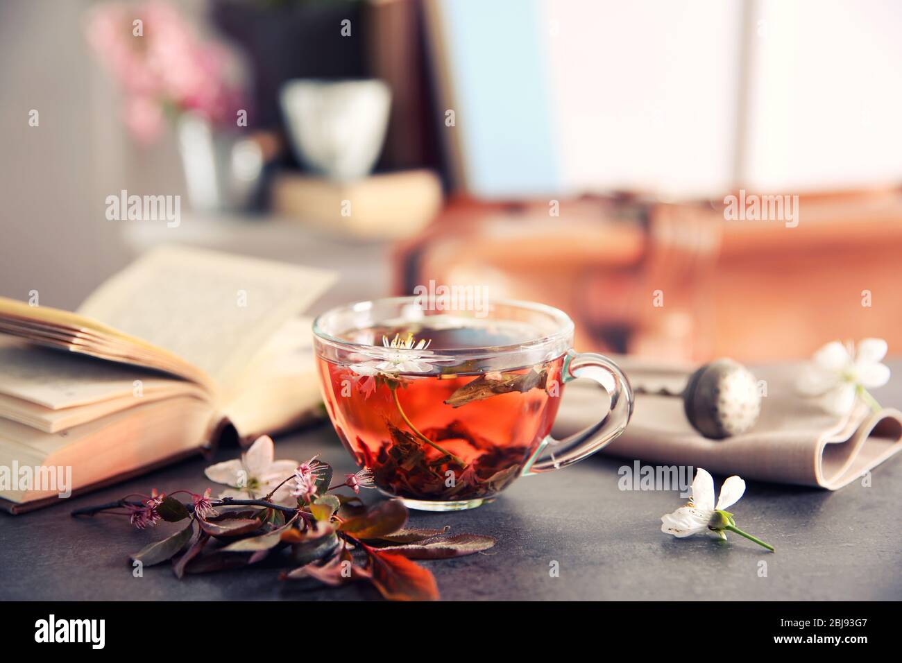 Cup of tea with flowers on brown table Stock Photo - Alamy
