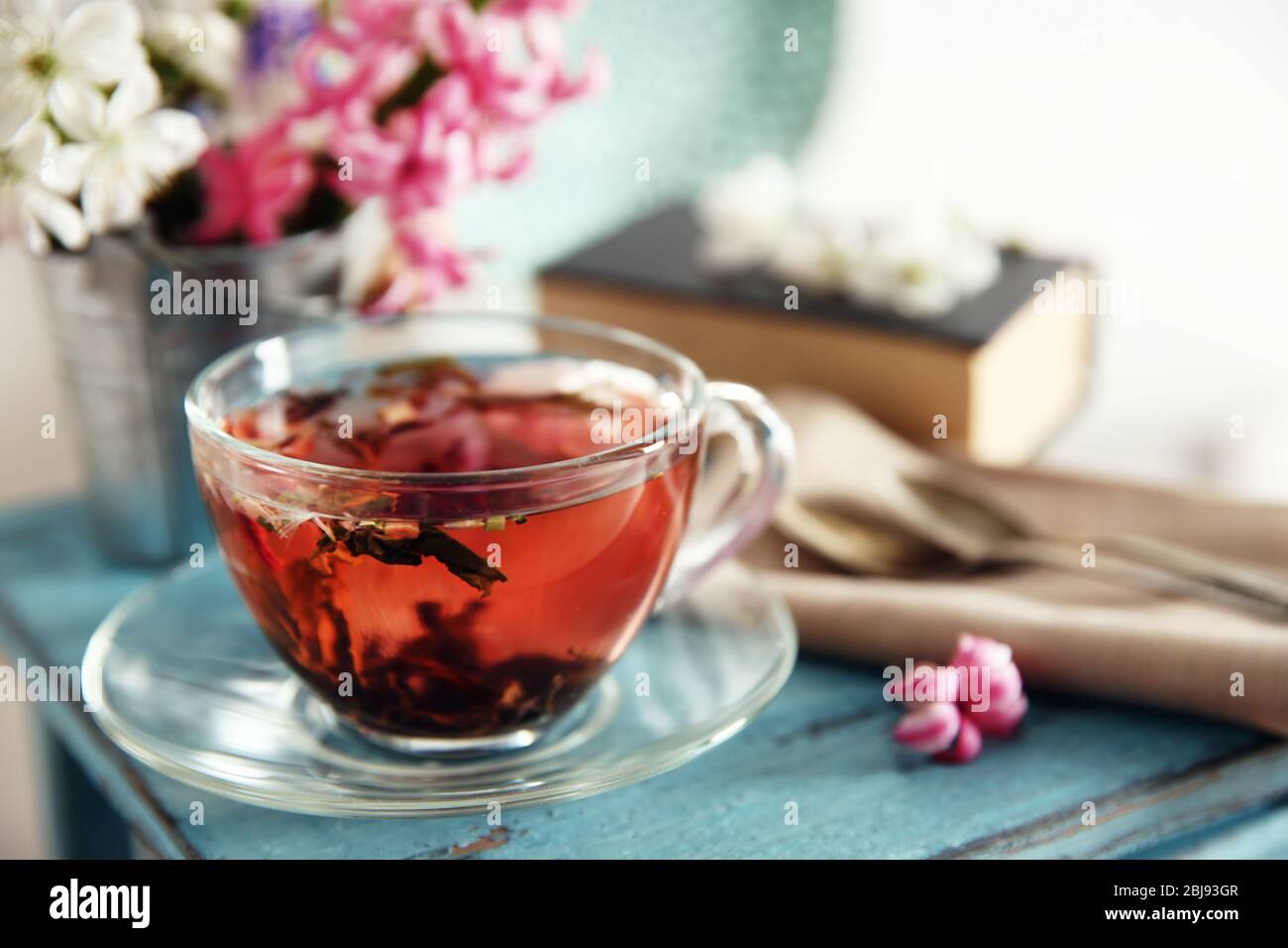 Cup of tea with flowers on wooden stool Stock Photo - Alamy