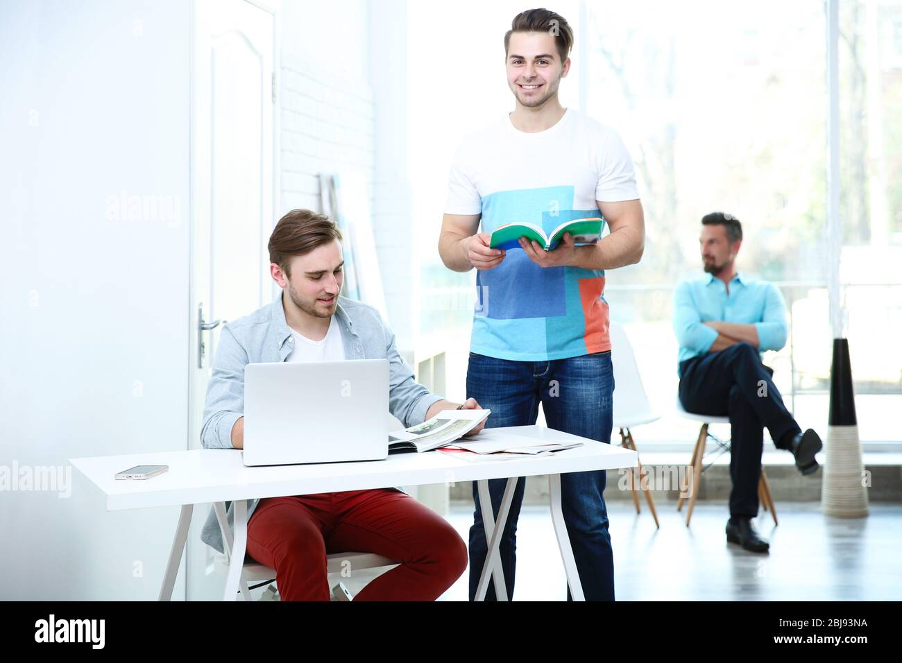 Young engineer working with blueprints at table indoors Stock Photo - Alamy