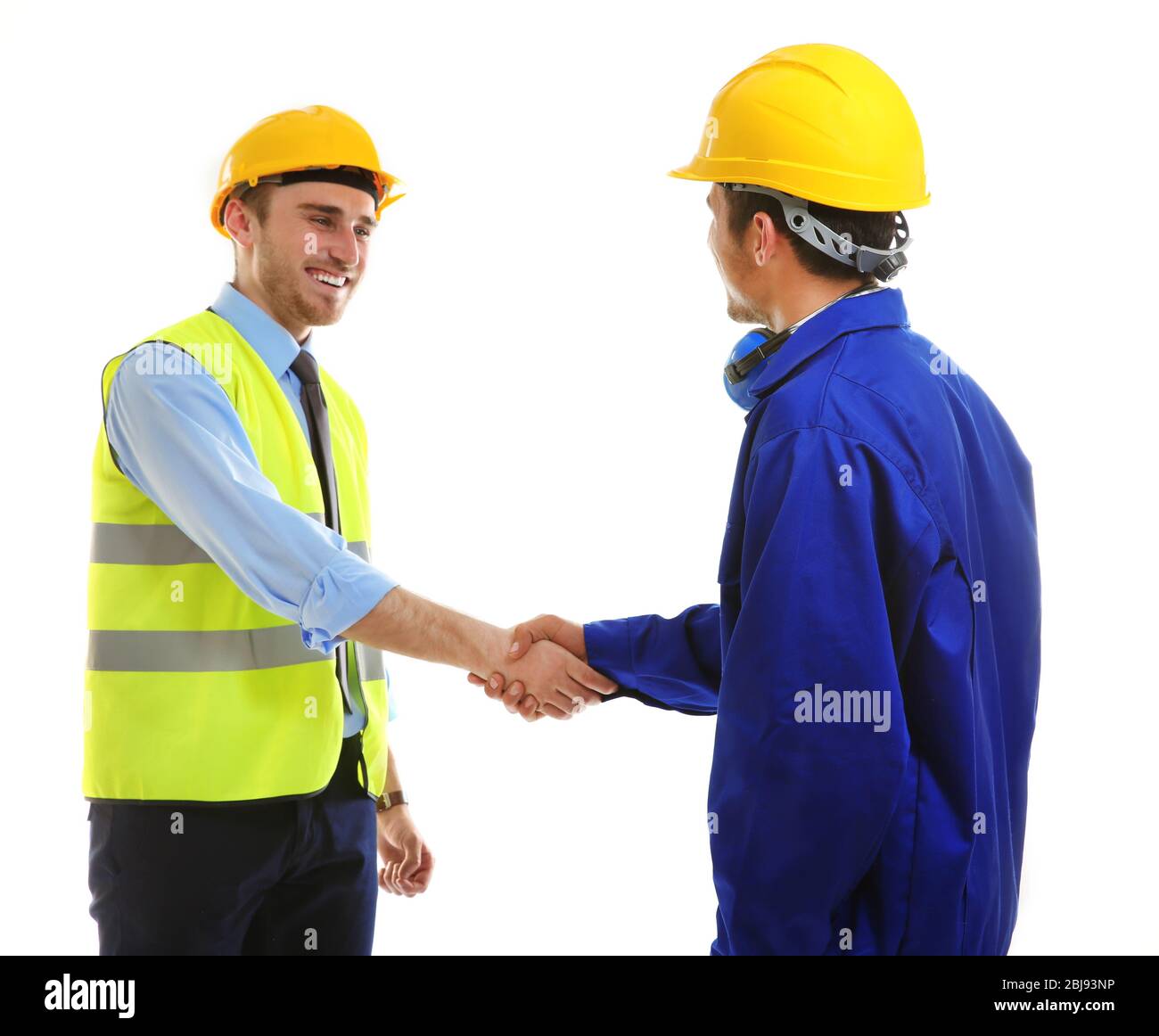 Two engineers shaking hands isolated on white Stock Photo - Alamy