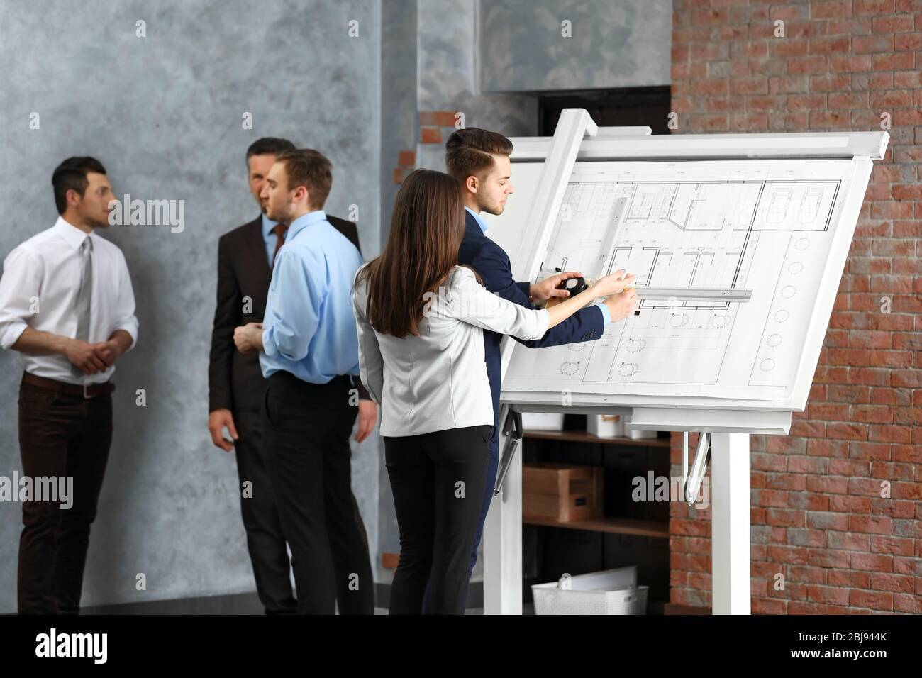 Engineers working with panel board indoors Stock Photo - Alamy