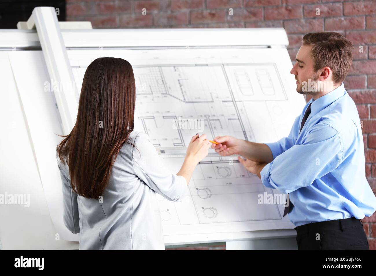 Engineers working with panel board indoors Stock Photo - Alamy