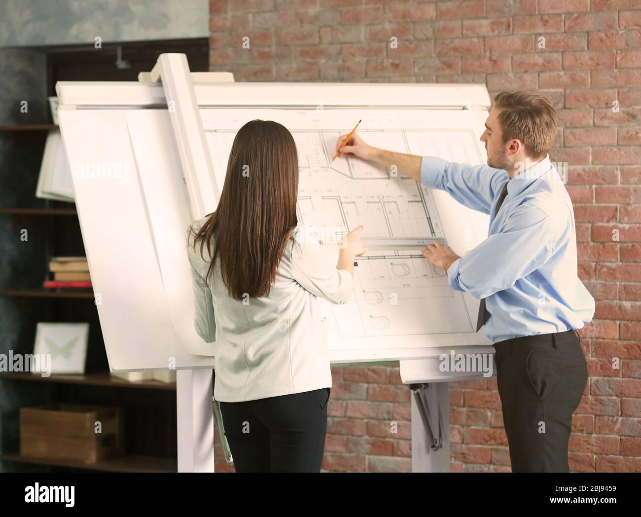 Engineers working with panel board indoors Stock Photo - Alamy