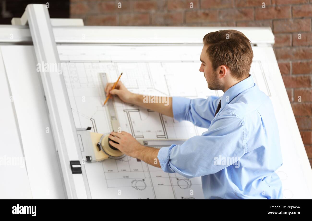 Engineer working with panel board indoors Stock Photo - Alamy