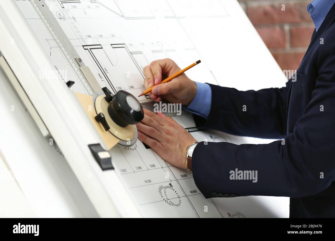 Engineer working with blueprint on panel board indoors Stock Photo - Alamy