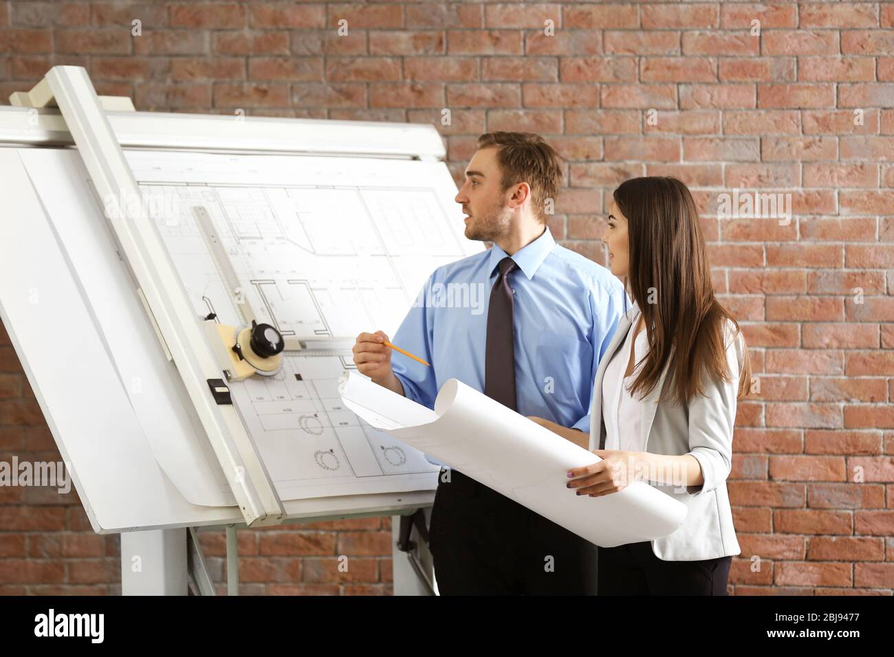 Engineers working with panel board indoors Stock Photo - Alamy