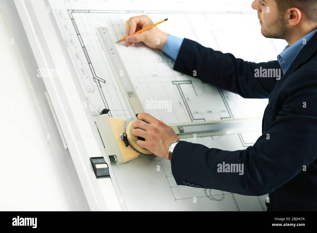 Engineer working with blueprint on panel board indoors Stock Photo - Alamy