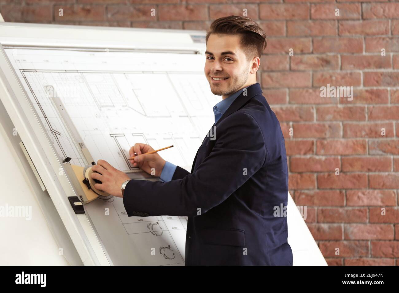 Engineer working with blueprint on panel board indoors Stock Photo - Alamy