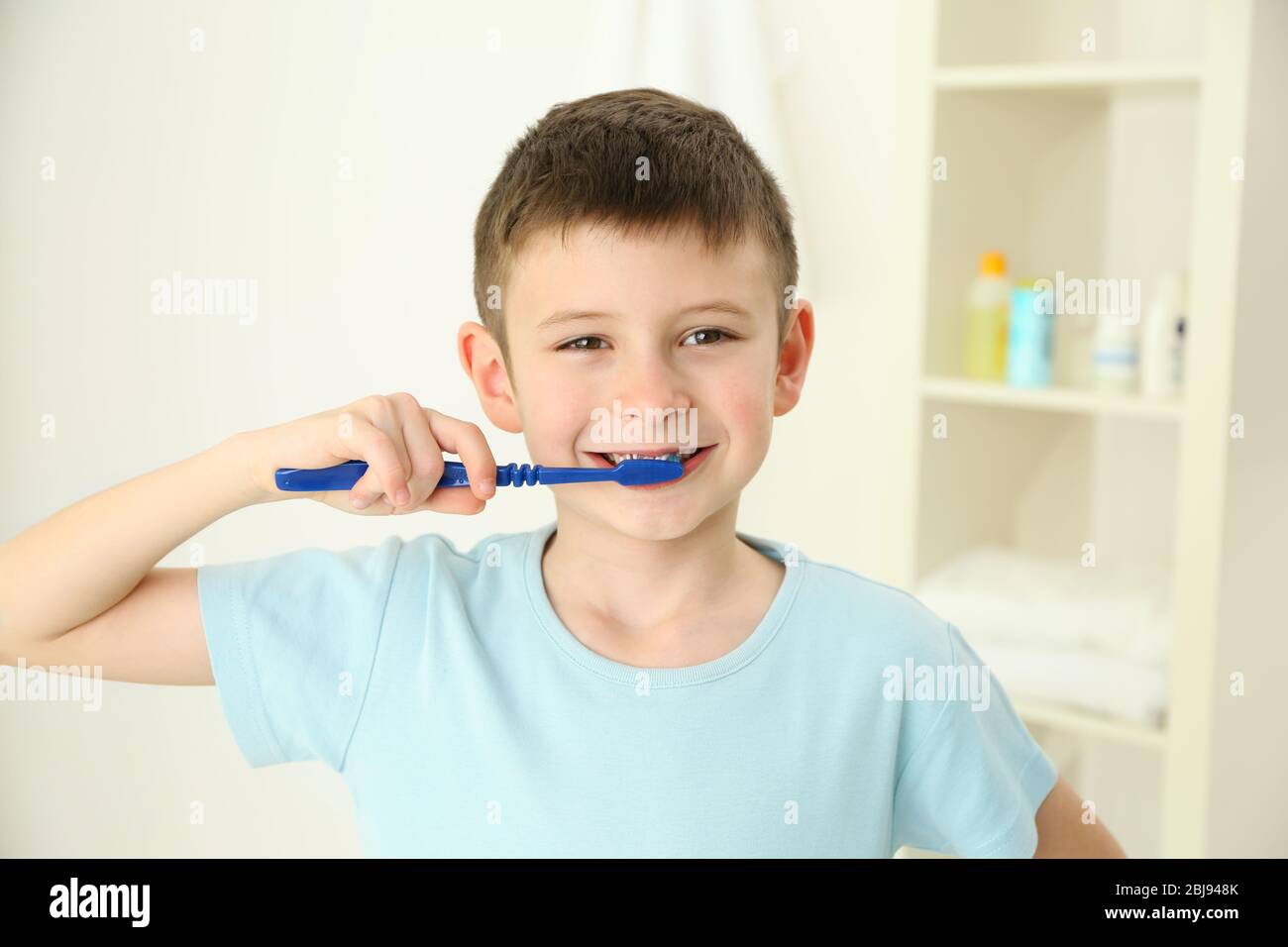 Smiling little boy brushing teeth, close up Stock Photo - Alamy