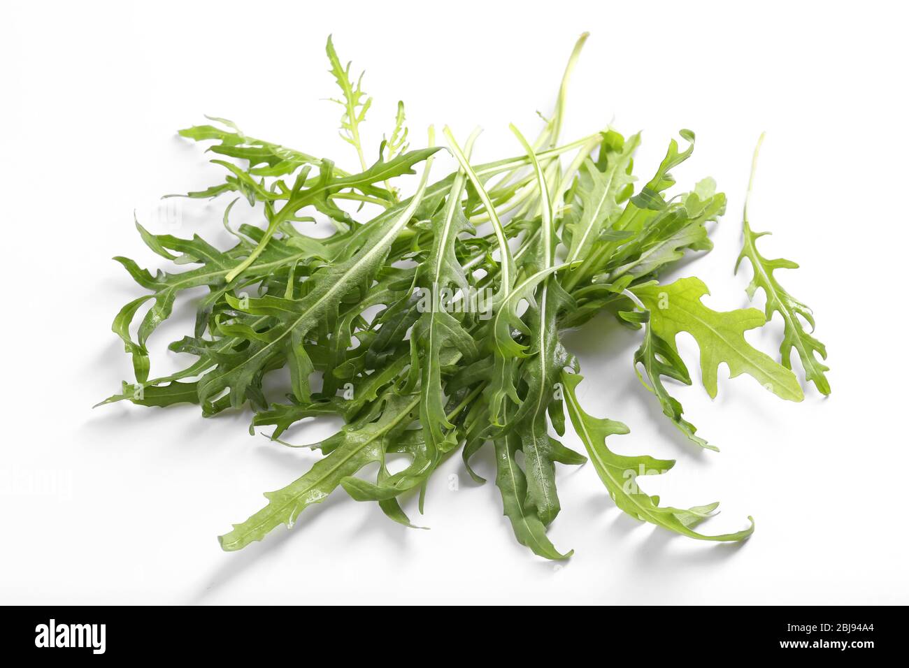 Fresh arugula leaves on white background Stock Photo - Alamy