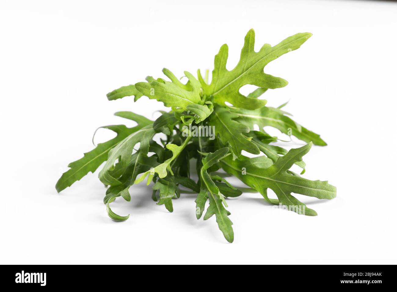 Fresh arugula leaves on white background Stock Photo - Alamy