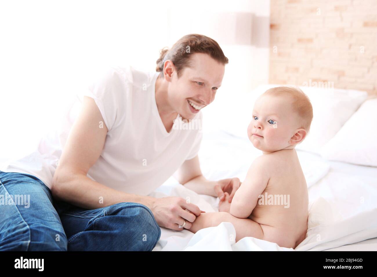 Young father is having fun with his little baby Stock Photo - Alamy