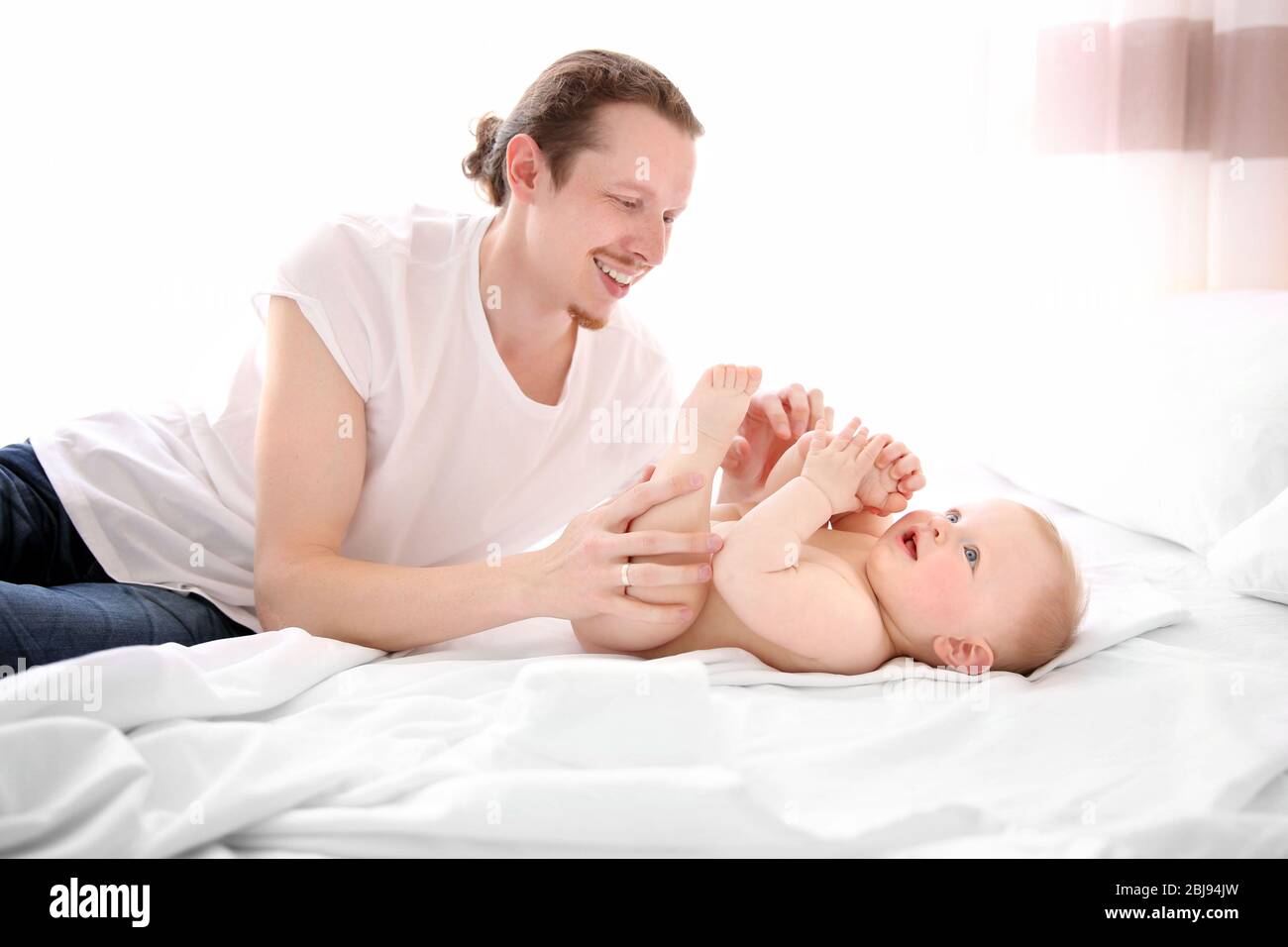 Young father is having fun with his little baby Stock Photo - Alamy