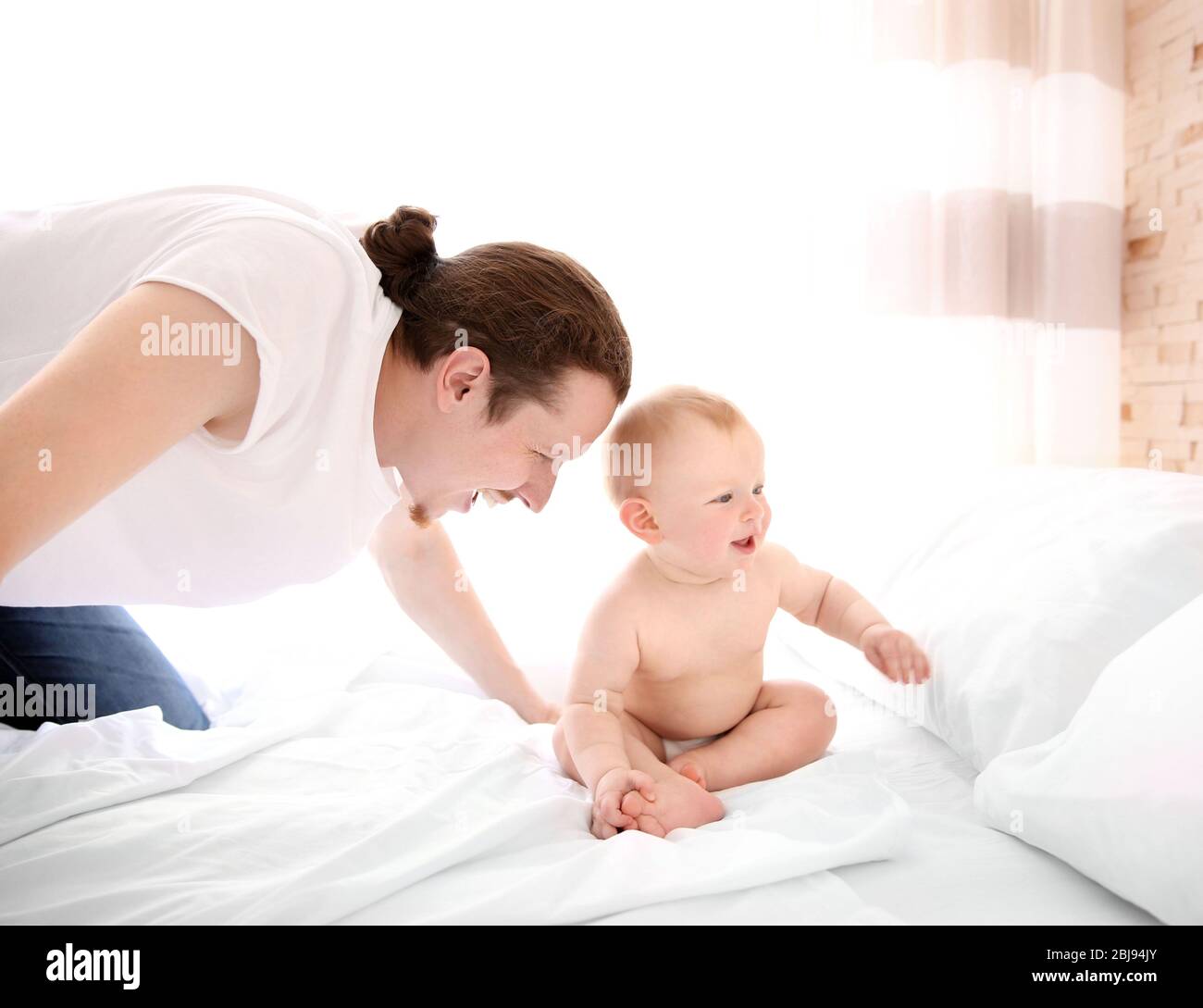 Young father is having fun with his little baby Stock Photo - Alamy