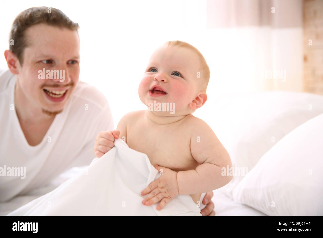Young father is having fun with his little baby Stock Photo - Alamy