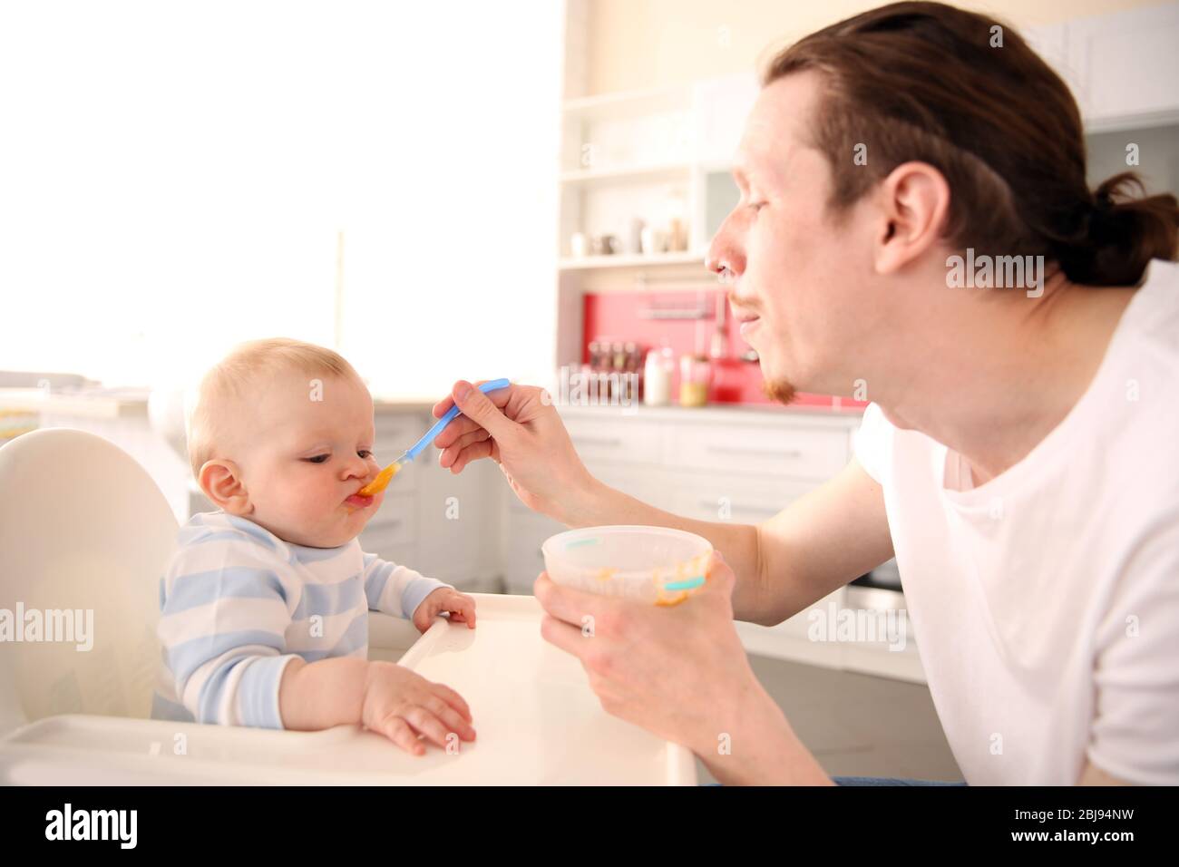 Father feeding his baby son Stock Photo - Alamy