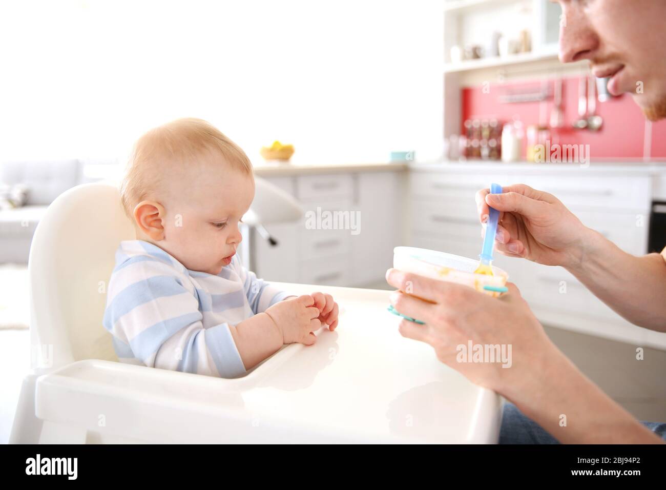 Father feeding his baby son Stock Photo - Alamy