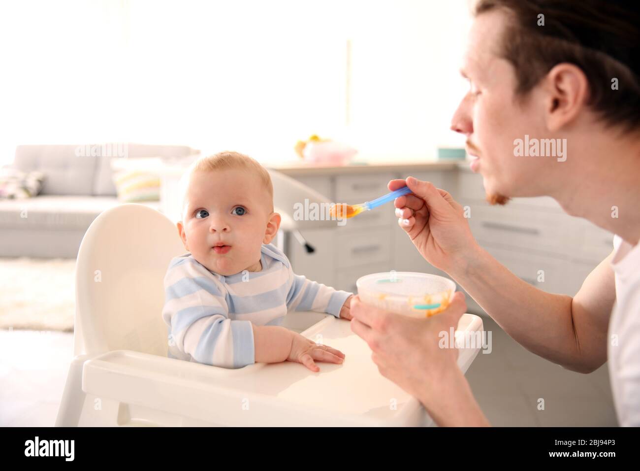 Father feeding his baby son Stock Photo - Alamy