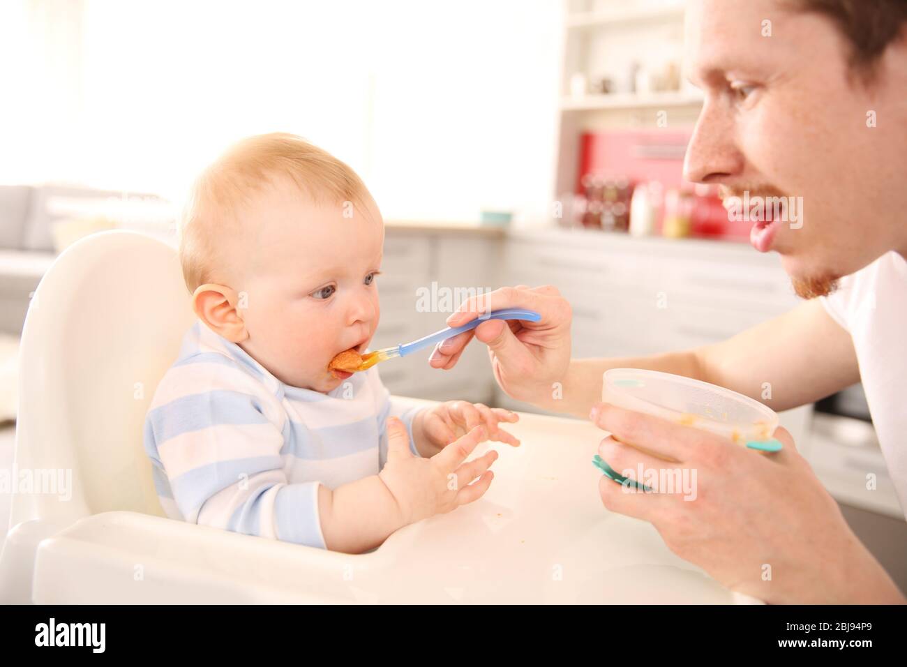 Father feeding his baby son Stock Photo - Alamy