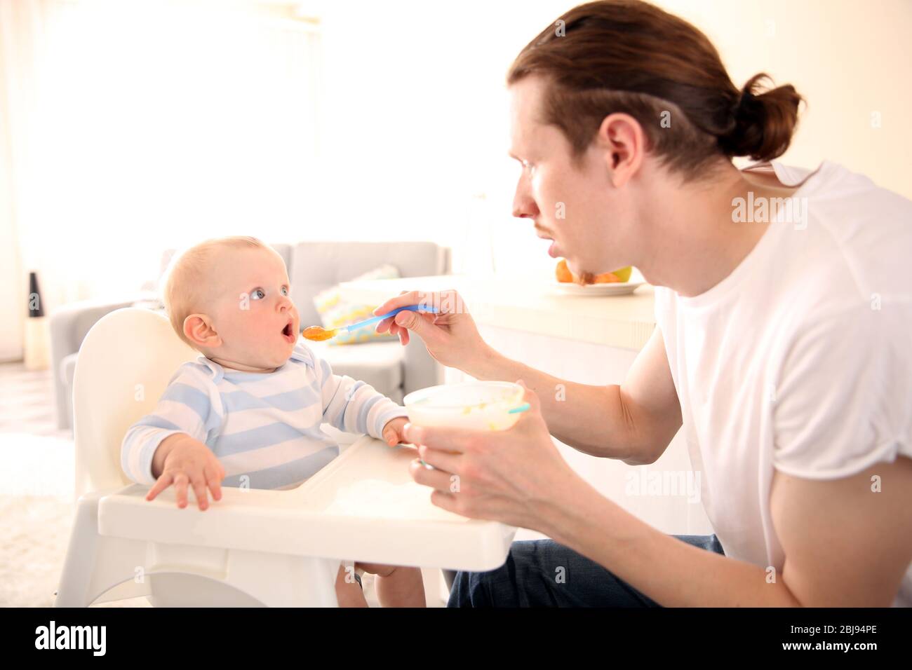 Father feeding his baby son Stock Photo - Alamy