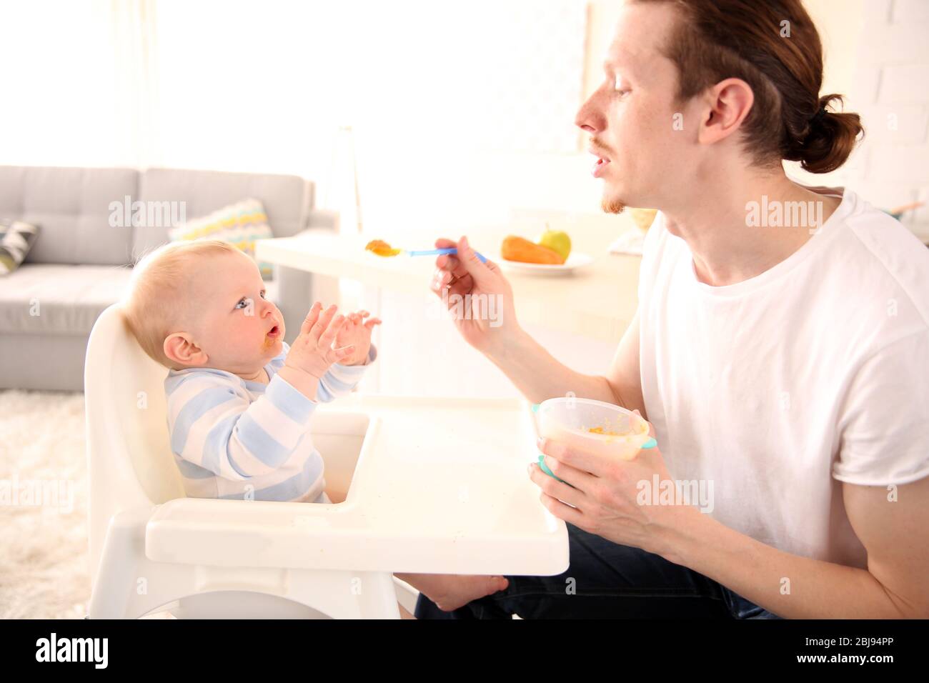 Father feeding his baby son Stock Photo - Alamy