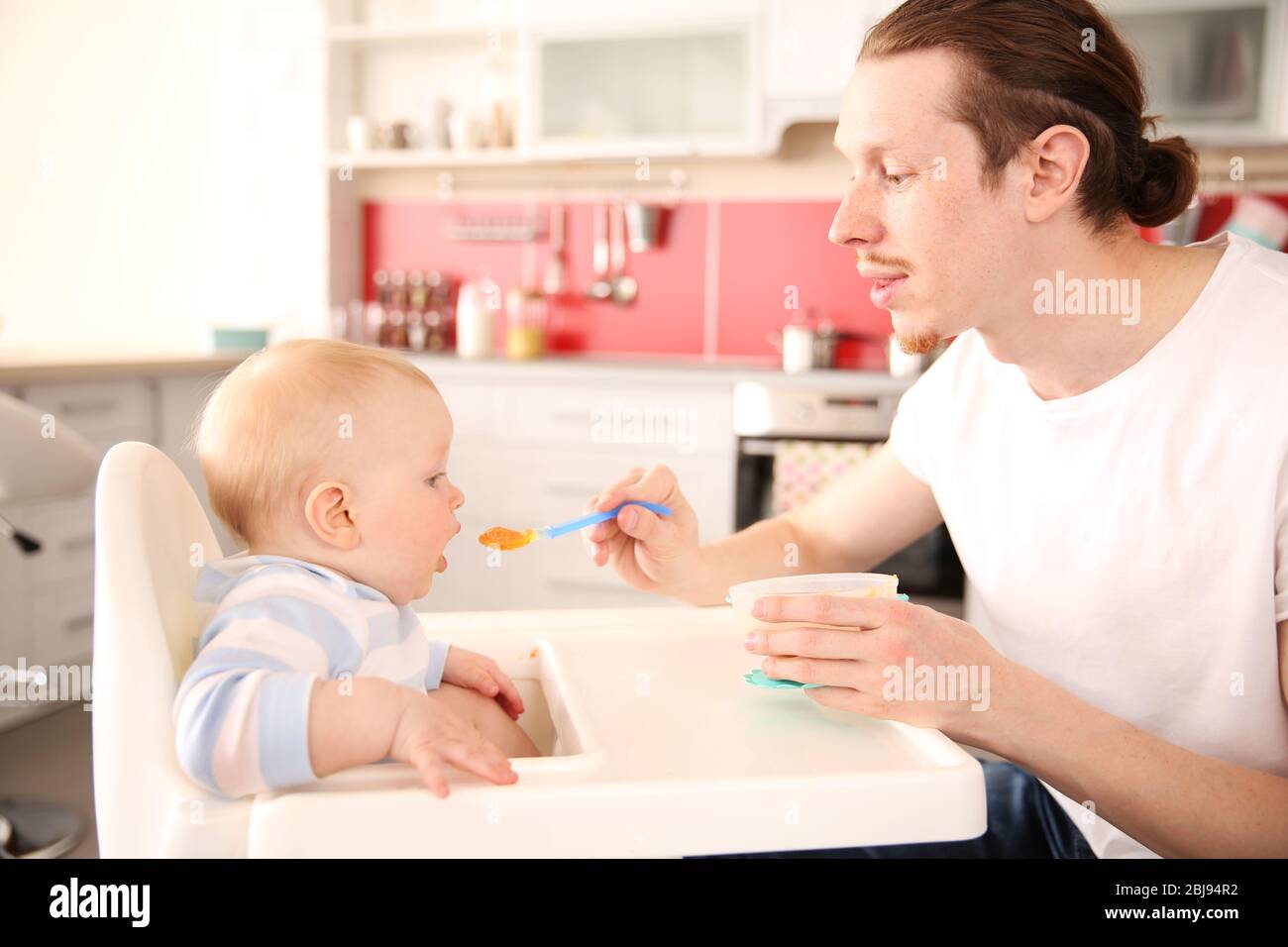 Father feeding his baby son Stock Photo - Alamy