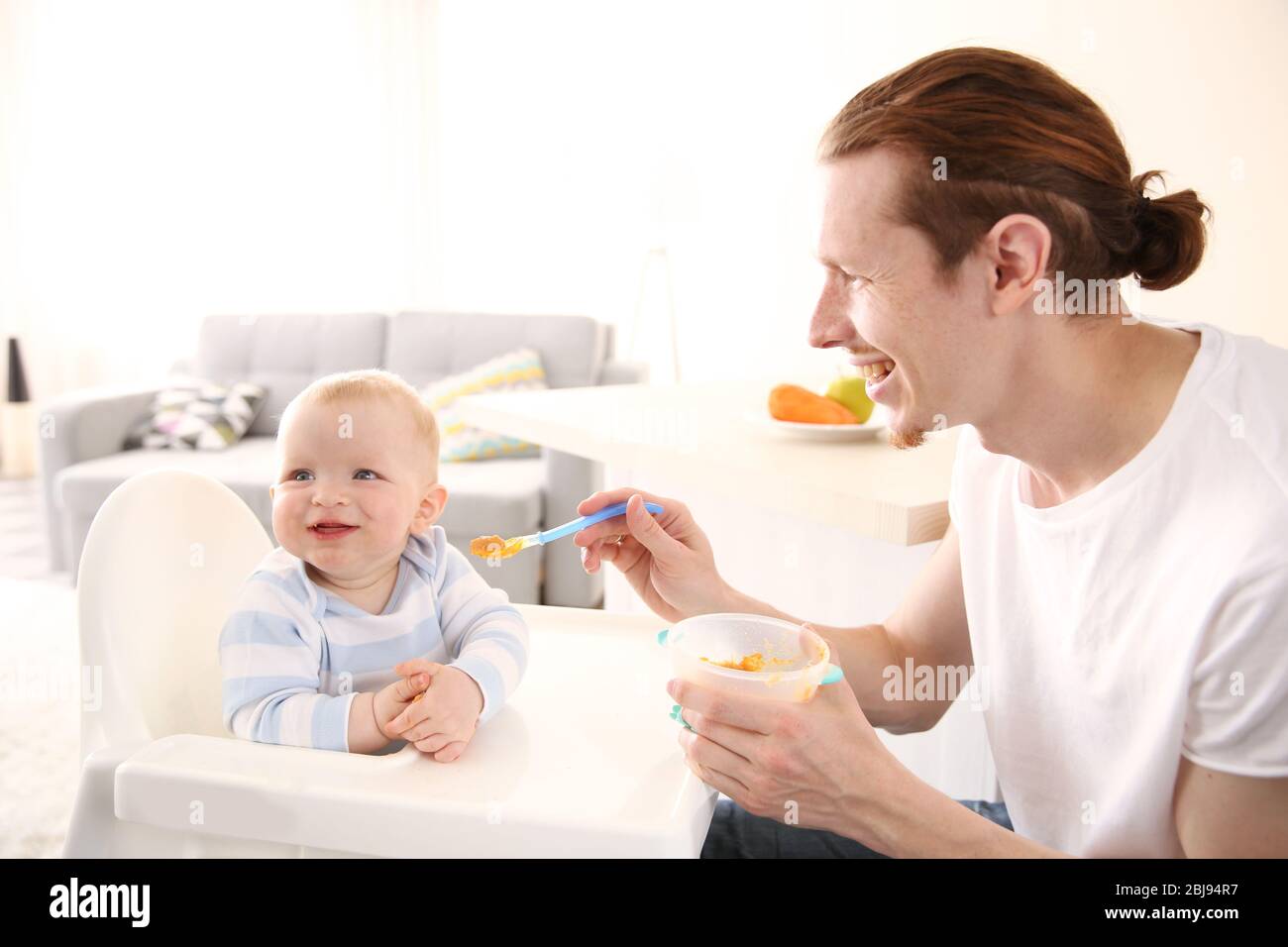 Father feeding his baby son Stock Photo - Alamy
