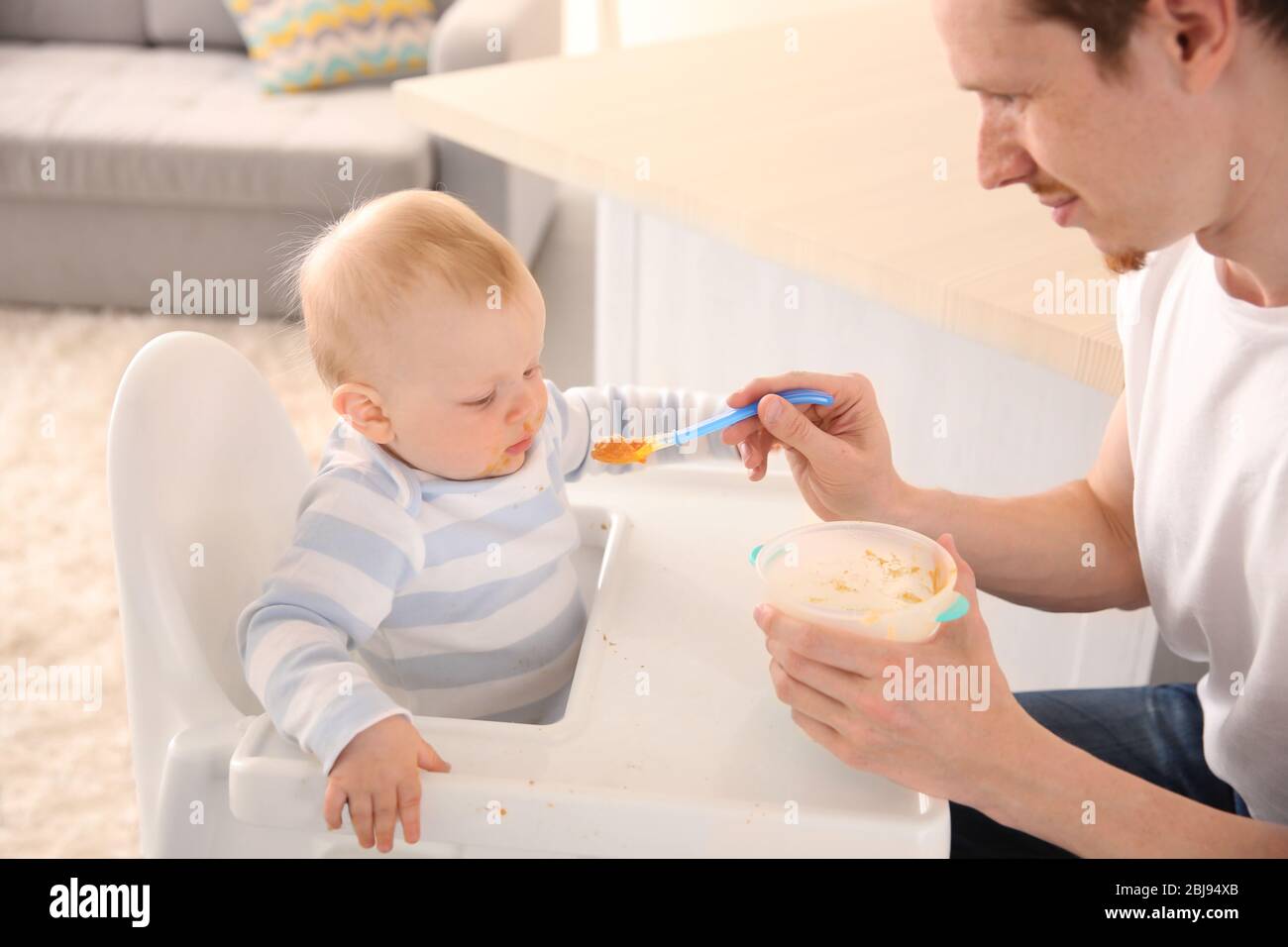Father feeding his baby son Stock Photo - Alamy