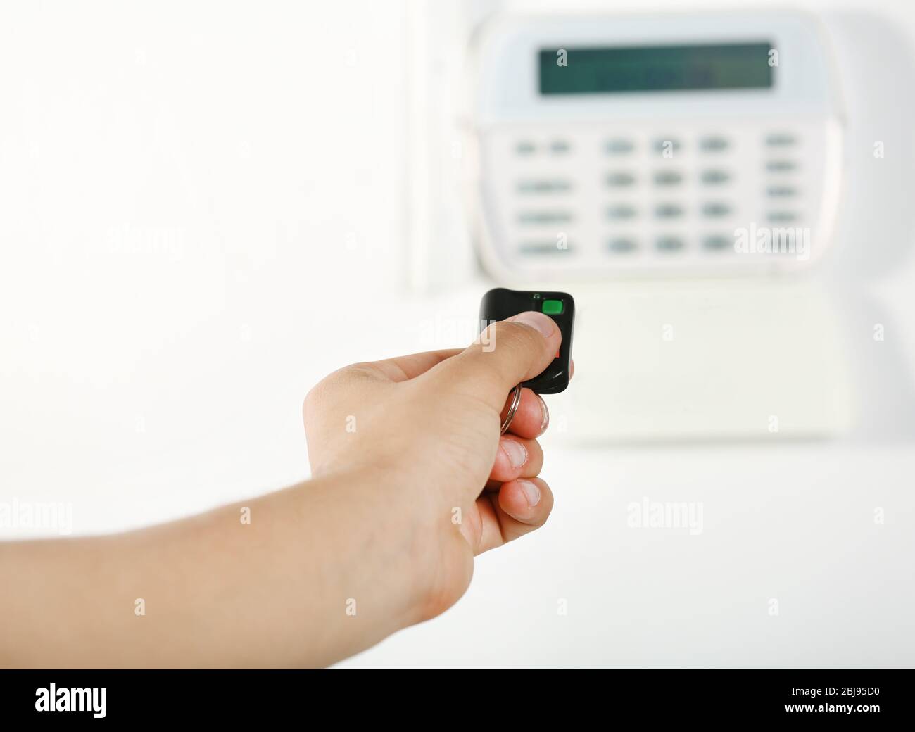 Male hand using electronic key on a house alarm Stock Photo - Alamy