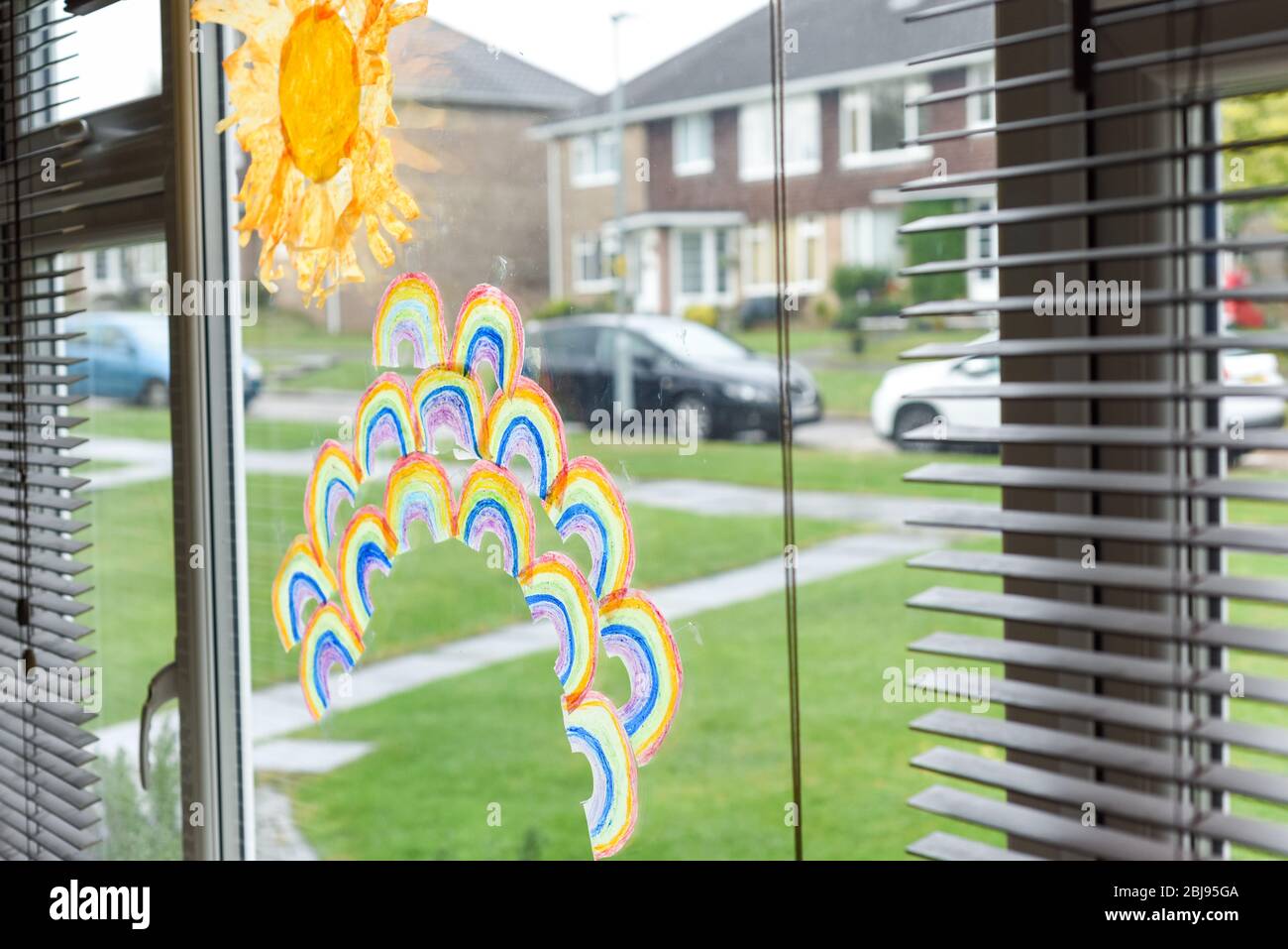 Kids drawings of rainbows in a window during covid-19 lockdown in uk ...