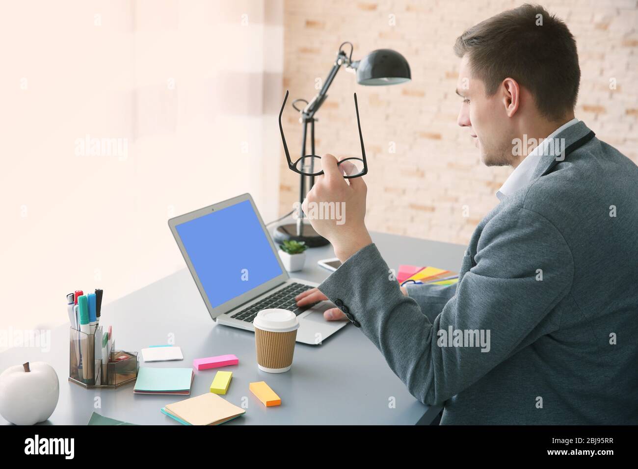 Man working at computer at office Stock Photo - Alamy