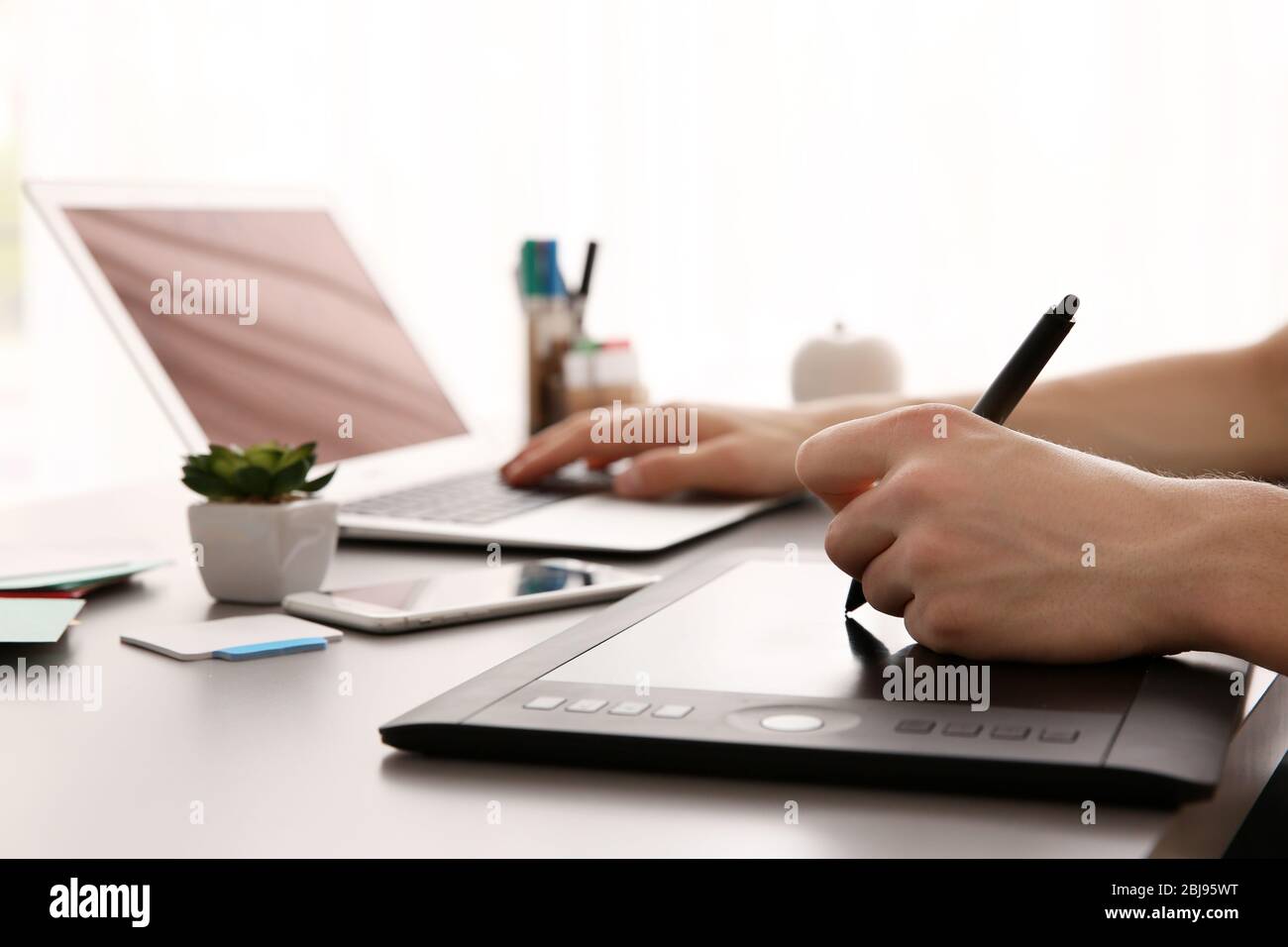 Man using graphic tablet at office Stock Photo - Alamy