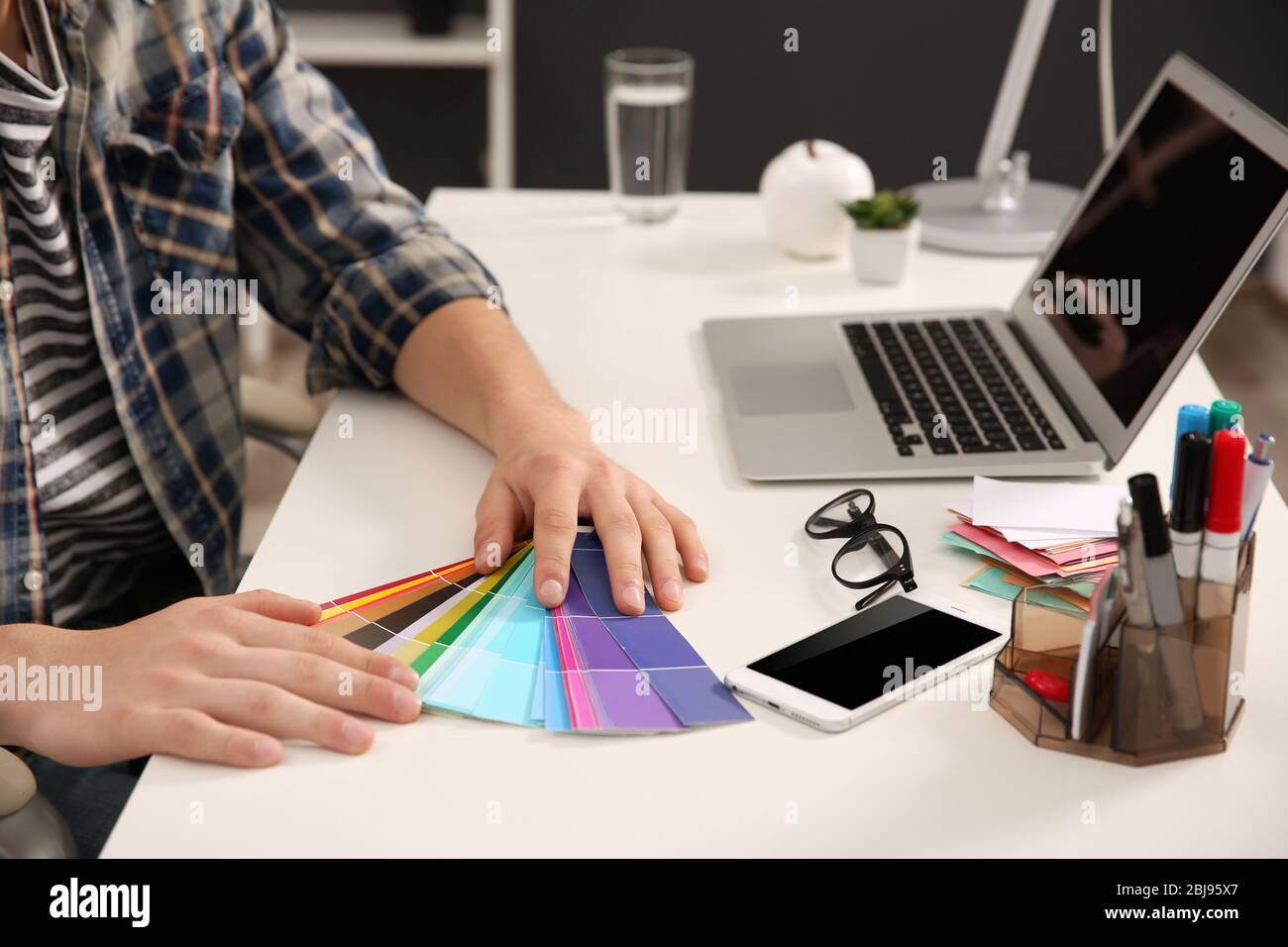 Man working with color samples at office Stock Photo - Alamy