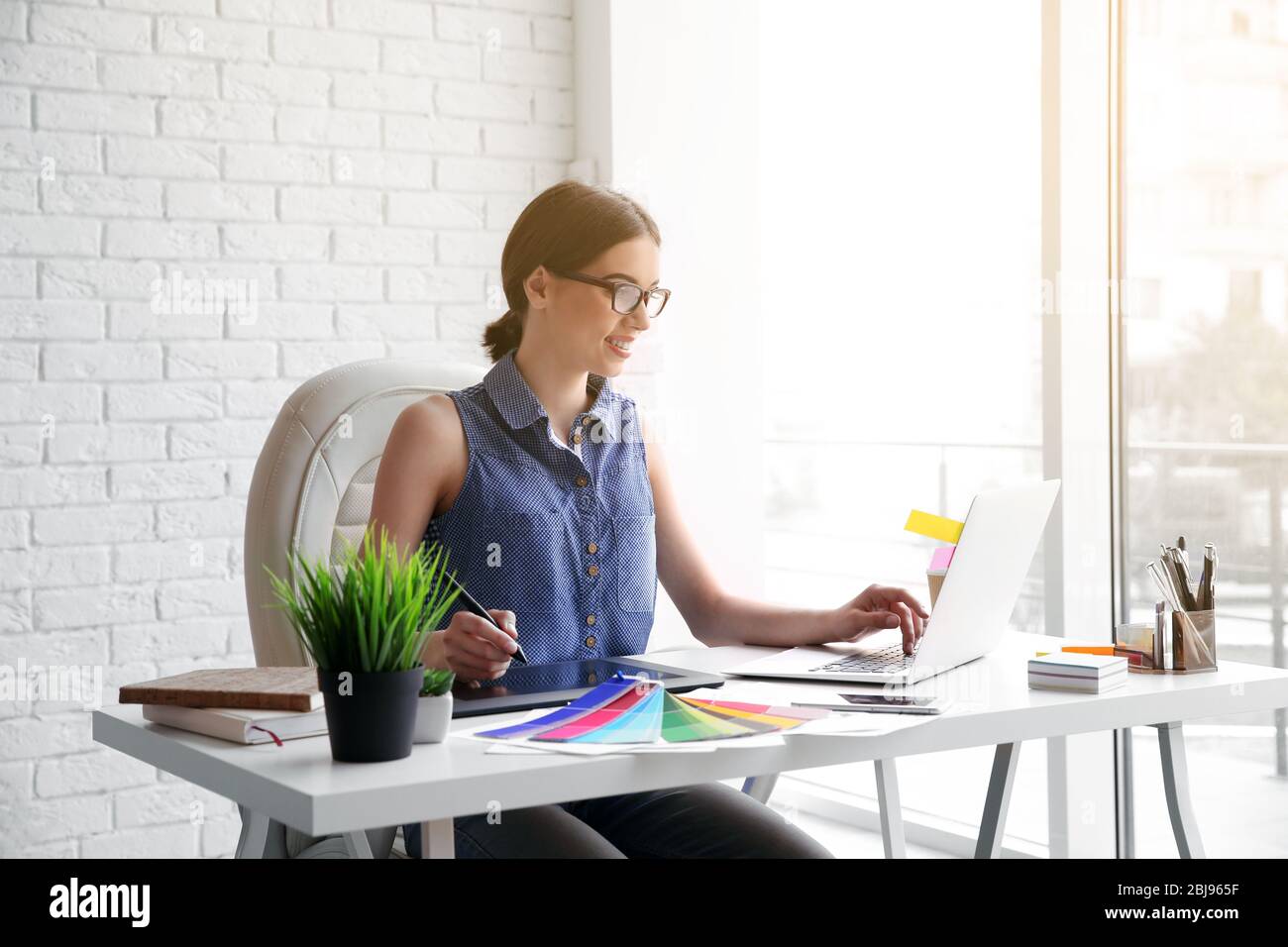 Woman using graphic tablet at office Stock Photo - Alamy