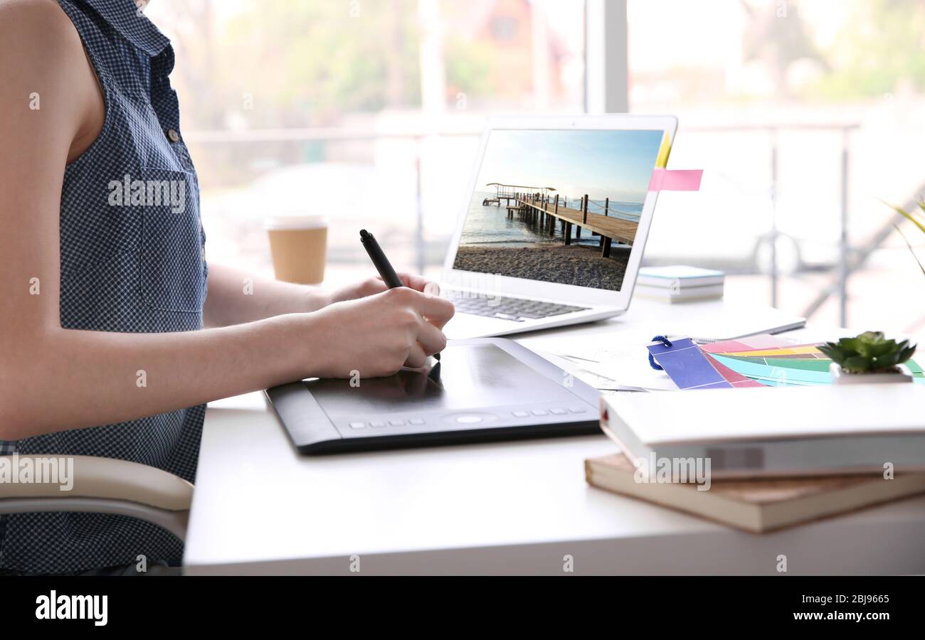 Woman using graphic tablet at office Stock Photo - Alamy