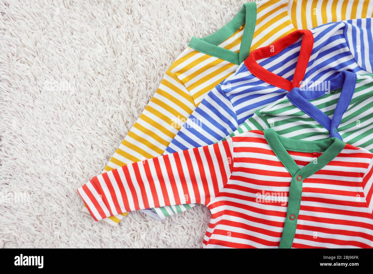 Baby clothes on light background Stock Photo - Alamy