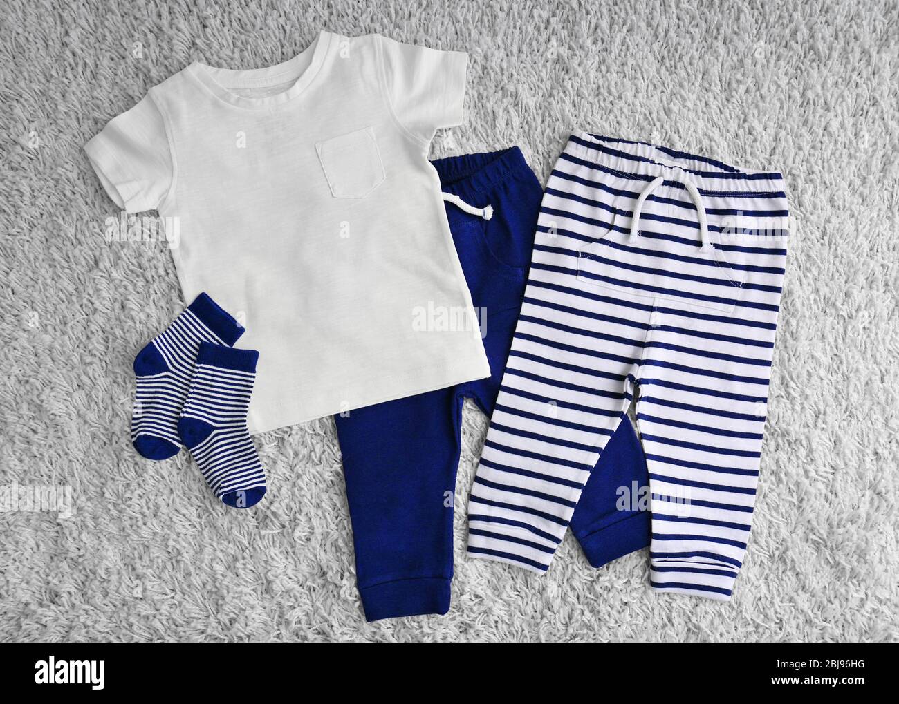 Child clothes on light background Stock Photo - Alamy