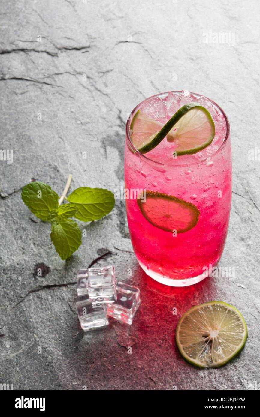 red soda lime drink with lime on stone Stock Photo - Alamy