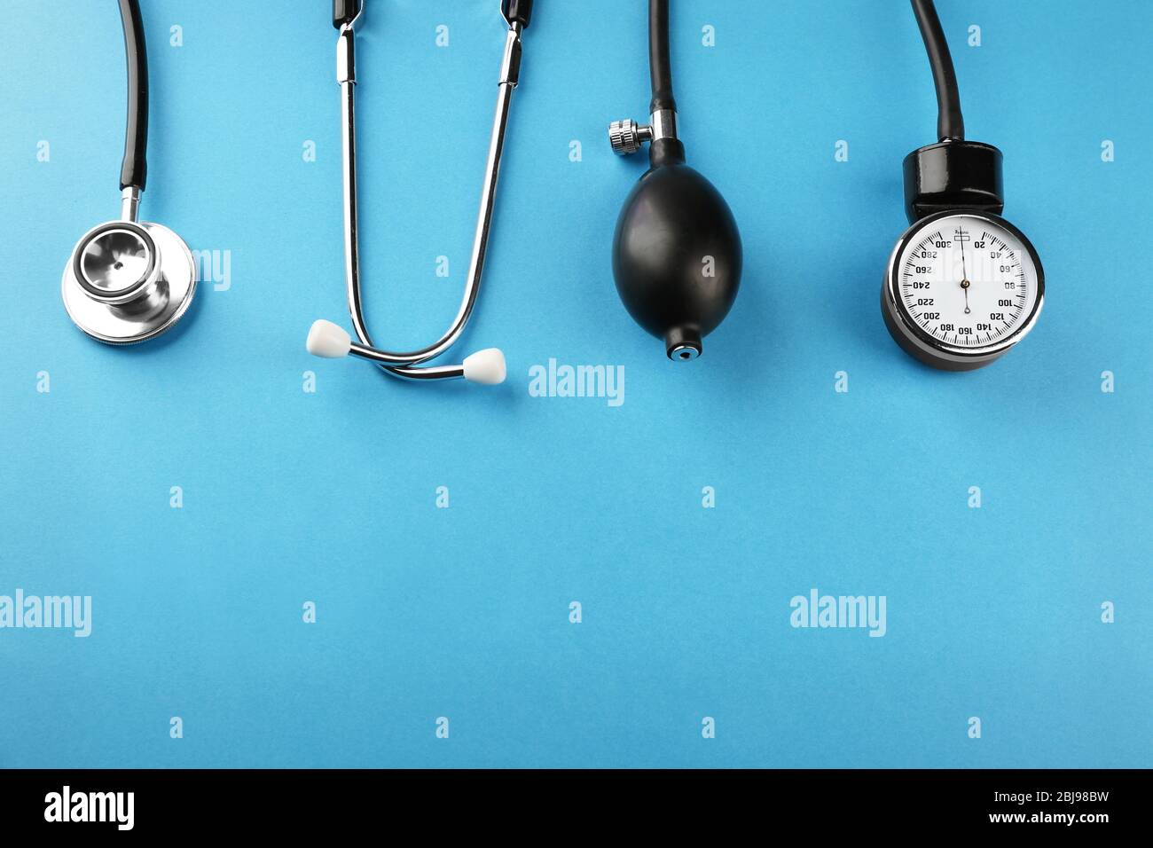 Medical manometer and a stethoscope on blue background Stock Photo - Alamy