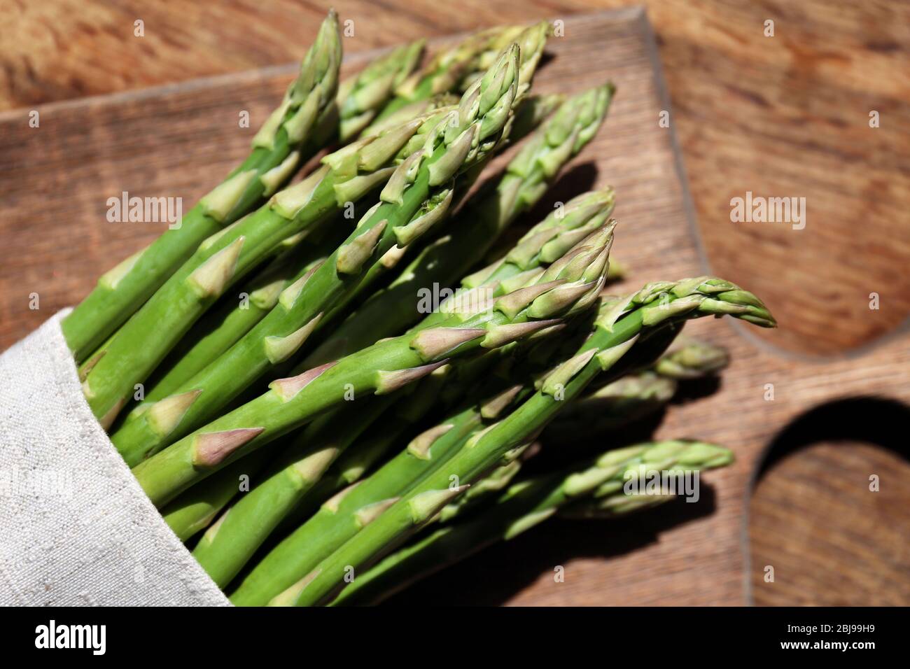 Asparagus on wooden table Stock Photo - Alamy