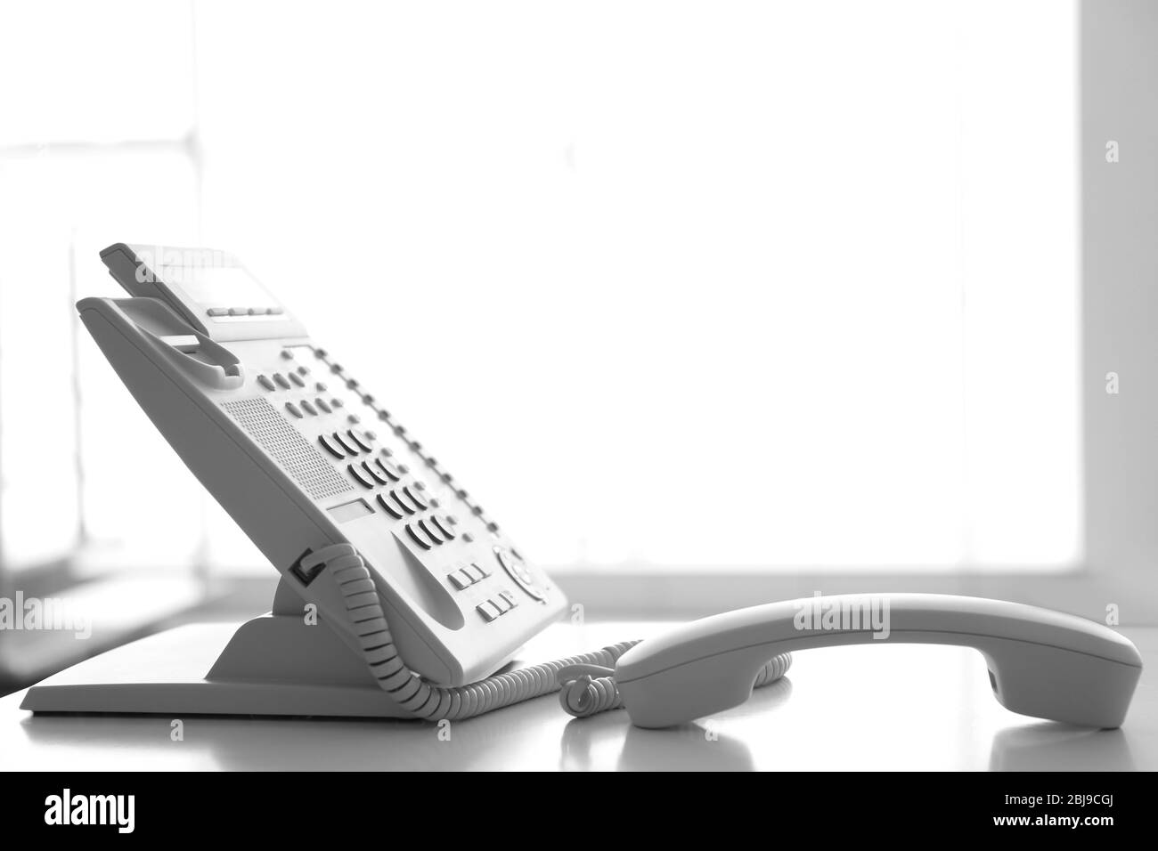 Modern office IP telephone set on light background Stock Photo - Alamy