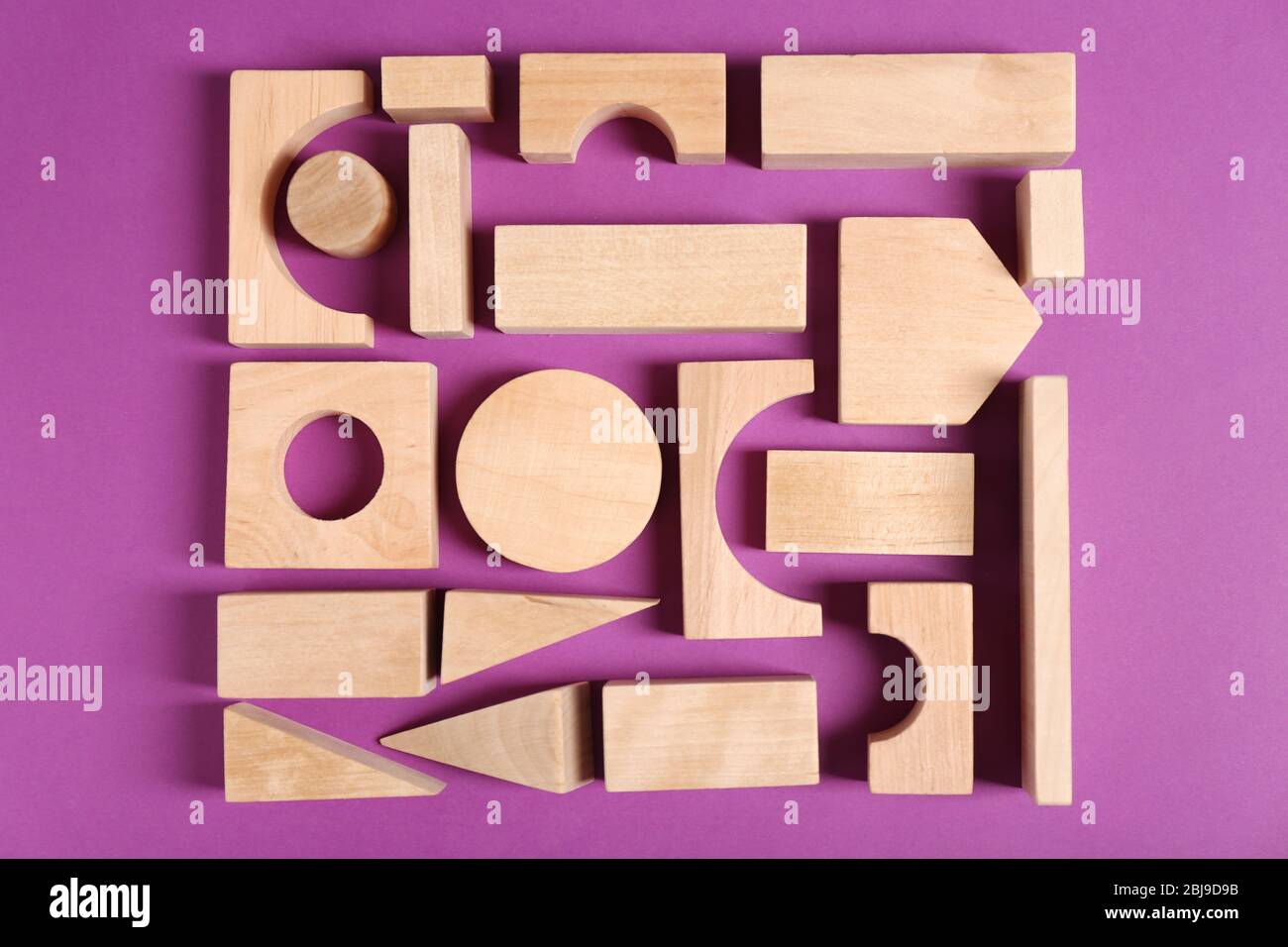 Wooden kids toys on purple background Stock Photo - Alamy