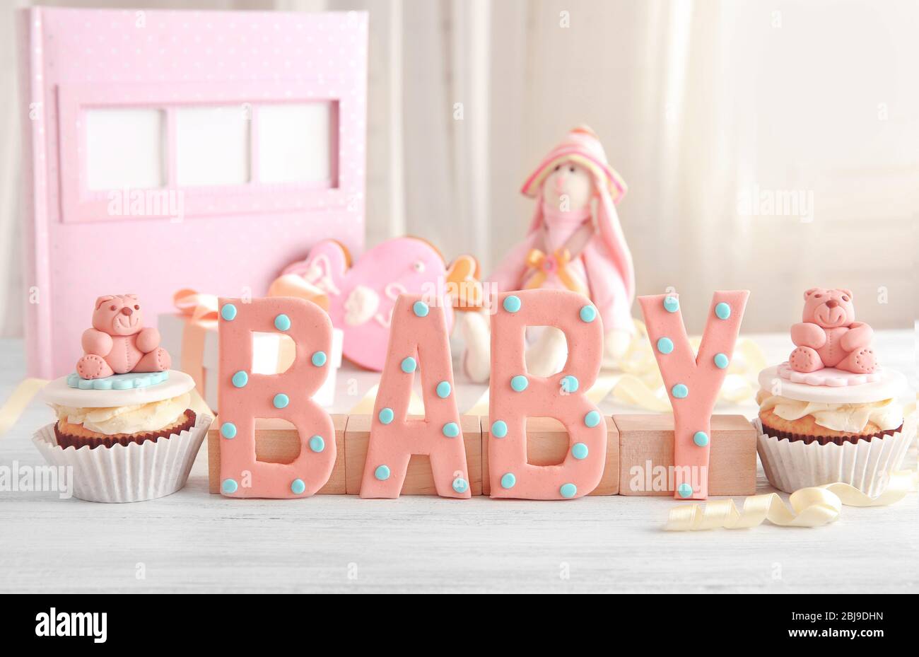 Letters of word baby and cupcake on the table Stock Photo - Alamy