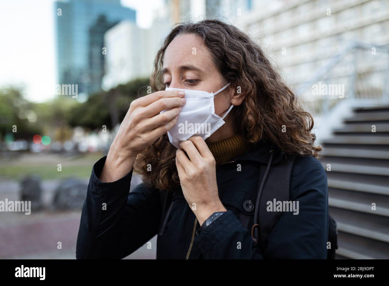 Putting on a mask hi-res stock photography and images - Alamy