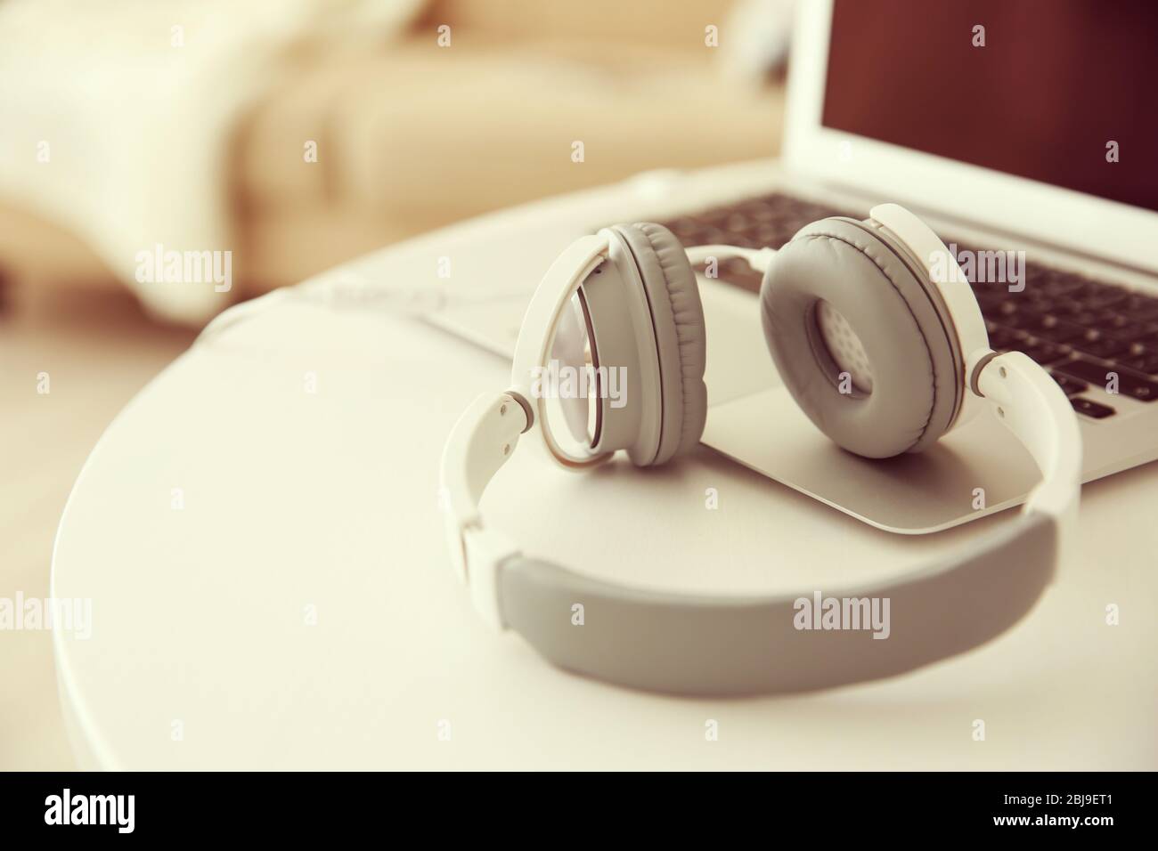 New headphones on the table in the room Stock Photo - Alamy