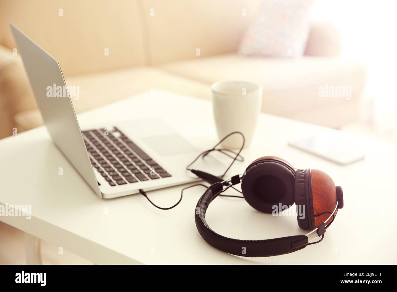 New headphones on the table in the room Stock Photo - Alamy