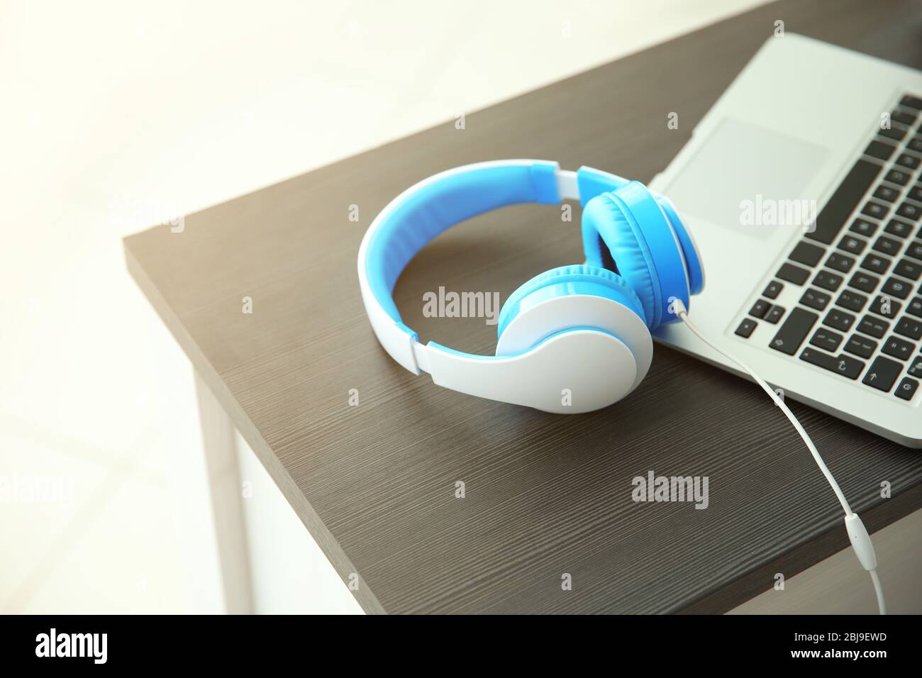 New headphones on the table, closeup Stock Photo - Alamy