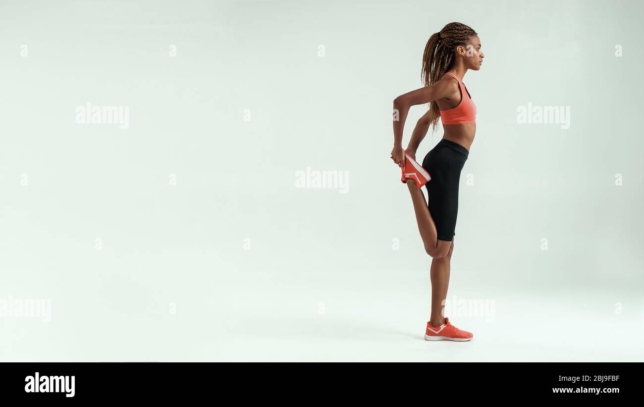 Staying flexible. Full length of young african woman with perfect body ...